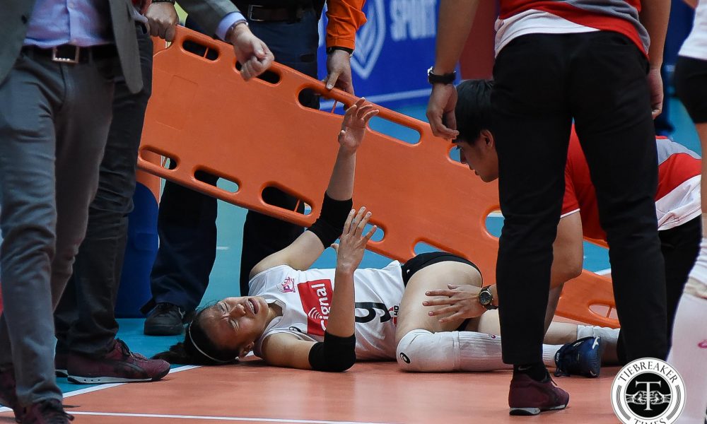 Janine Marciano stretchered out after apparent knee injury